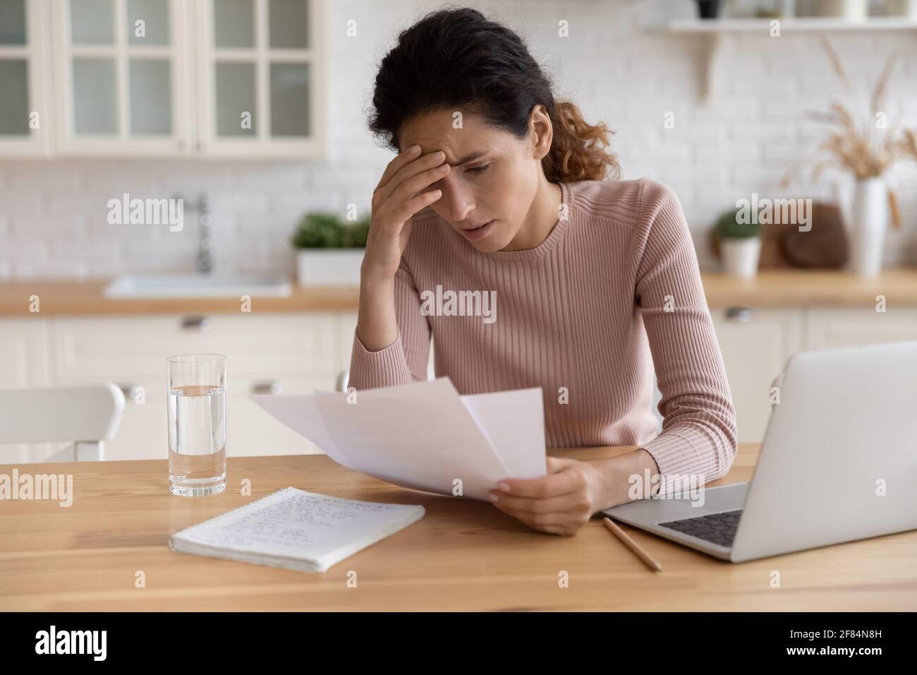 Stressed millennial female think on bank notification about business ...