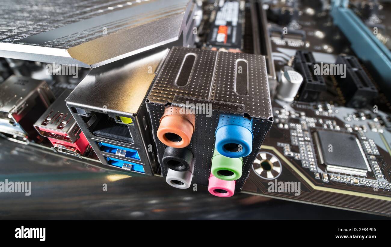 Modern computer motherboard. Colored audio, USB or LAN female ...