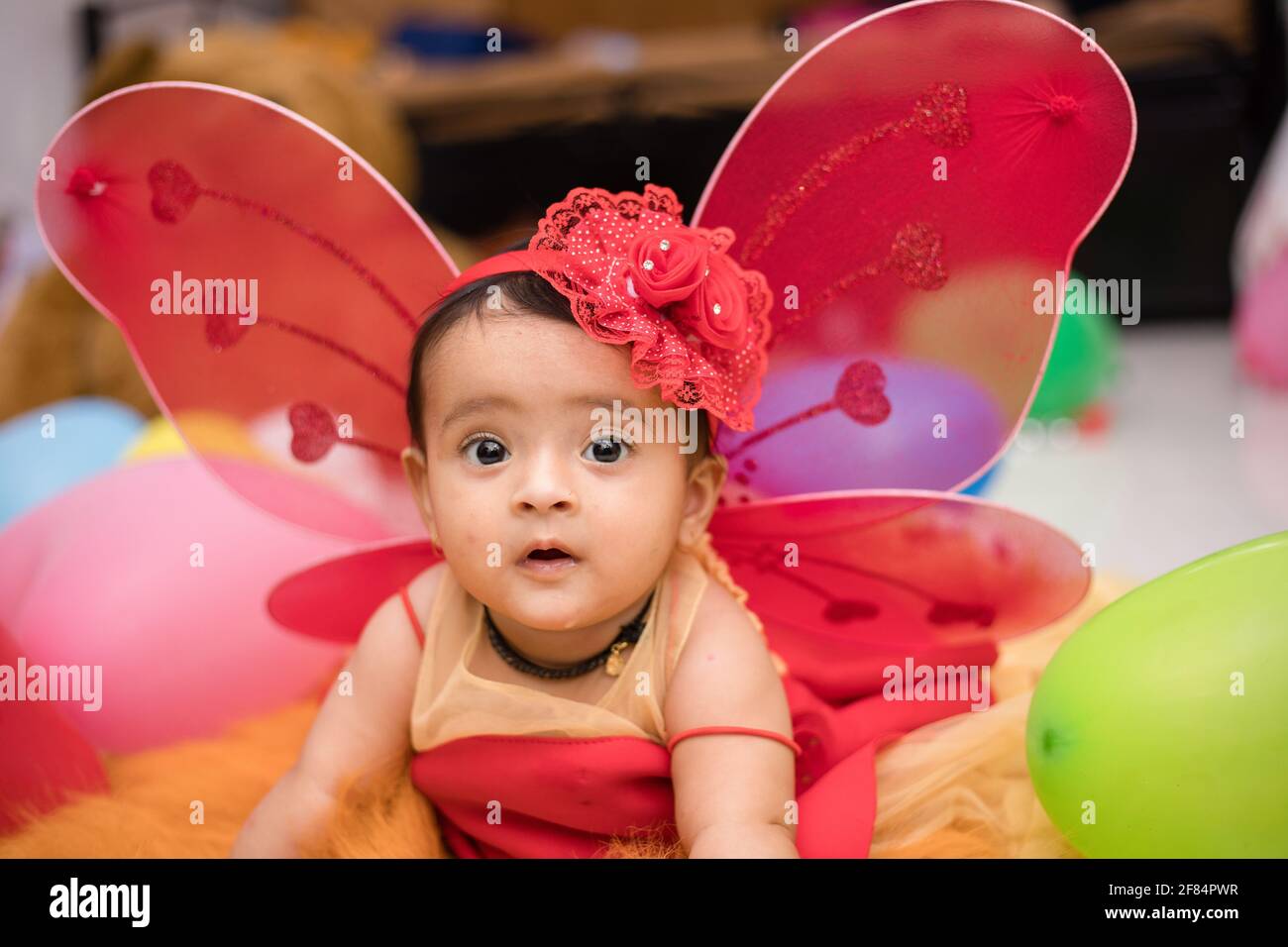 A closeup portrait of an Indian baby dressed as an angel, Mumbai, India ...