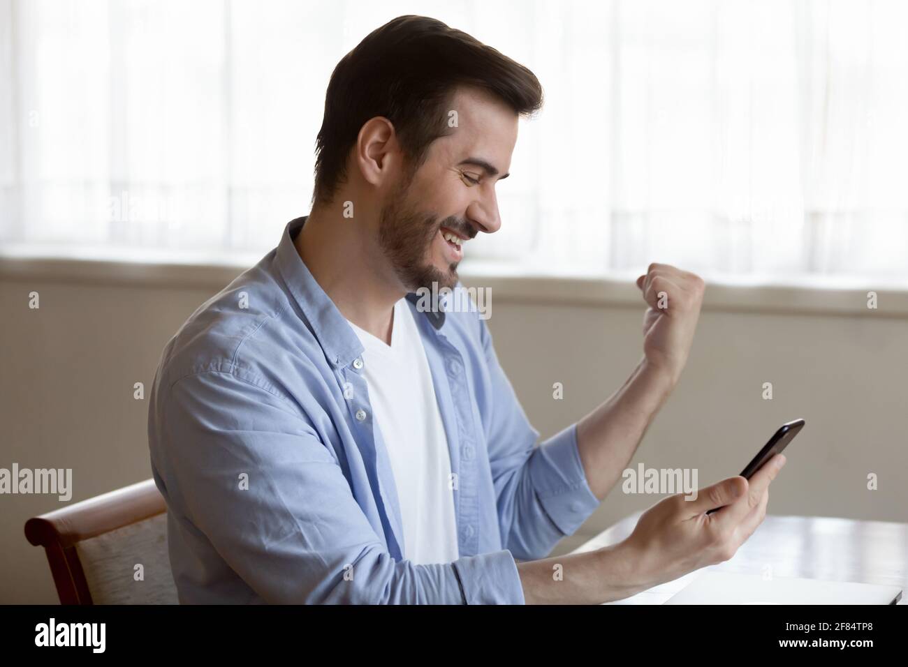 Excited businessman on cell hi-res stock photography and images - Alamy