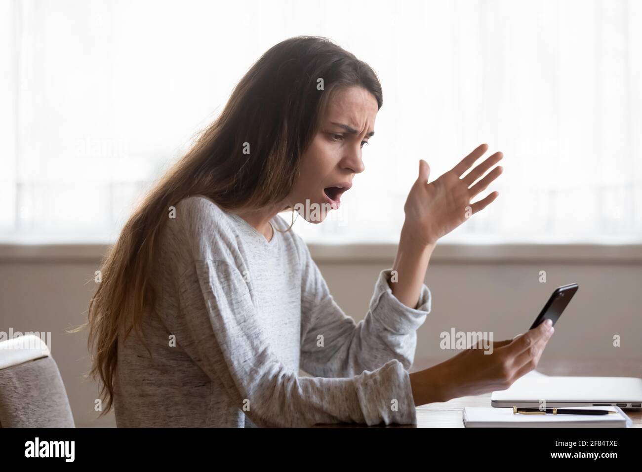 Frustrated female customer on mobile hi-res stock photography and ...