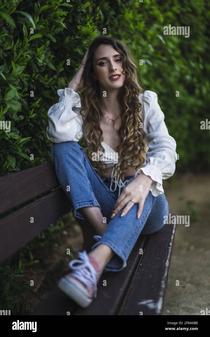 A vertical shot of a beautiful Spanish Caucasian woman wearing top and ...