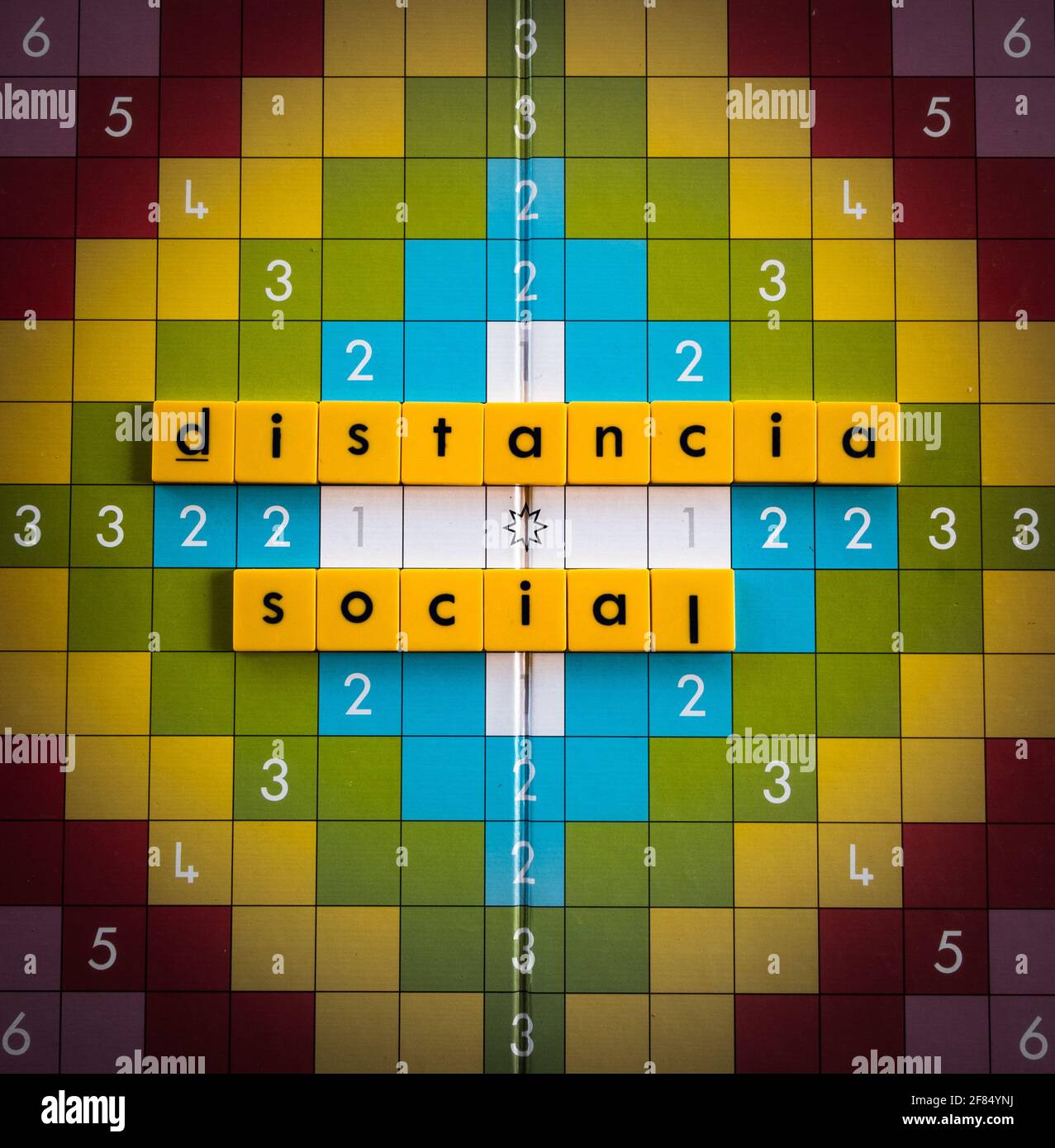 A word game board with “Distancia social-Social distancing” phrase ...