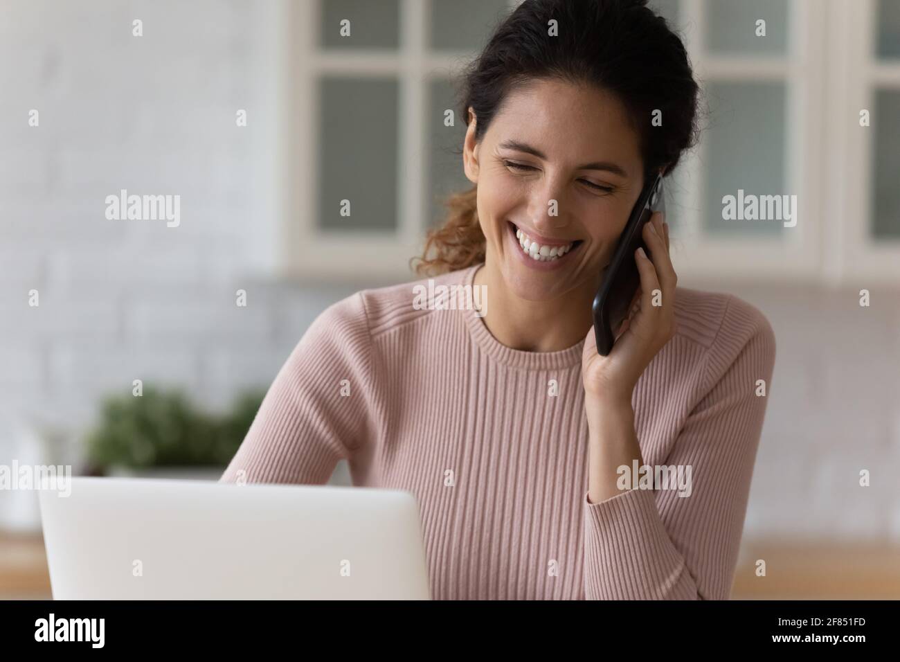 Positive young hispanic woman use cell computer in remote job Stock ...
