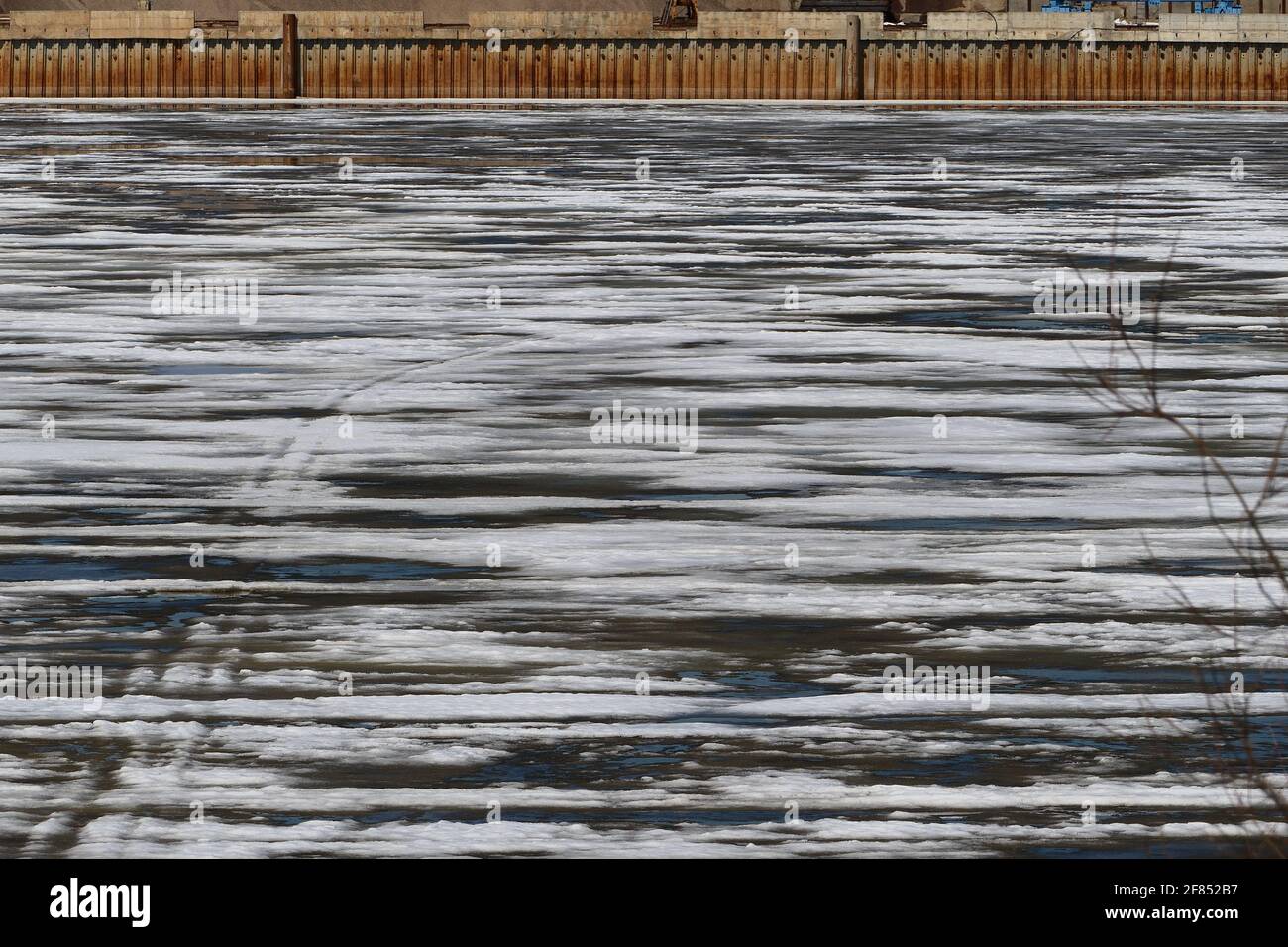 Spring ice on the river. Split the ice on the water in the river Stock ...