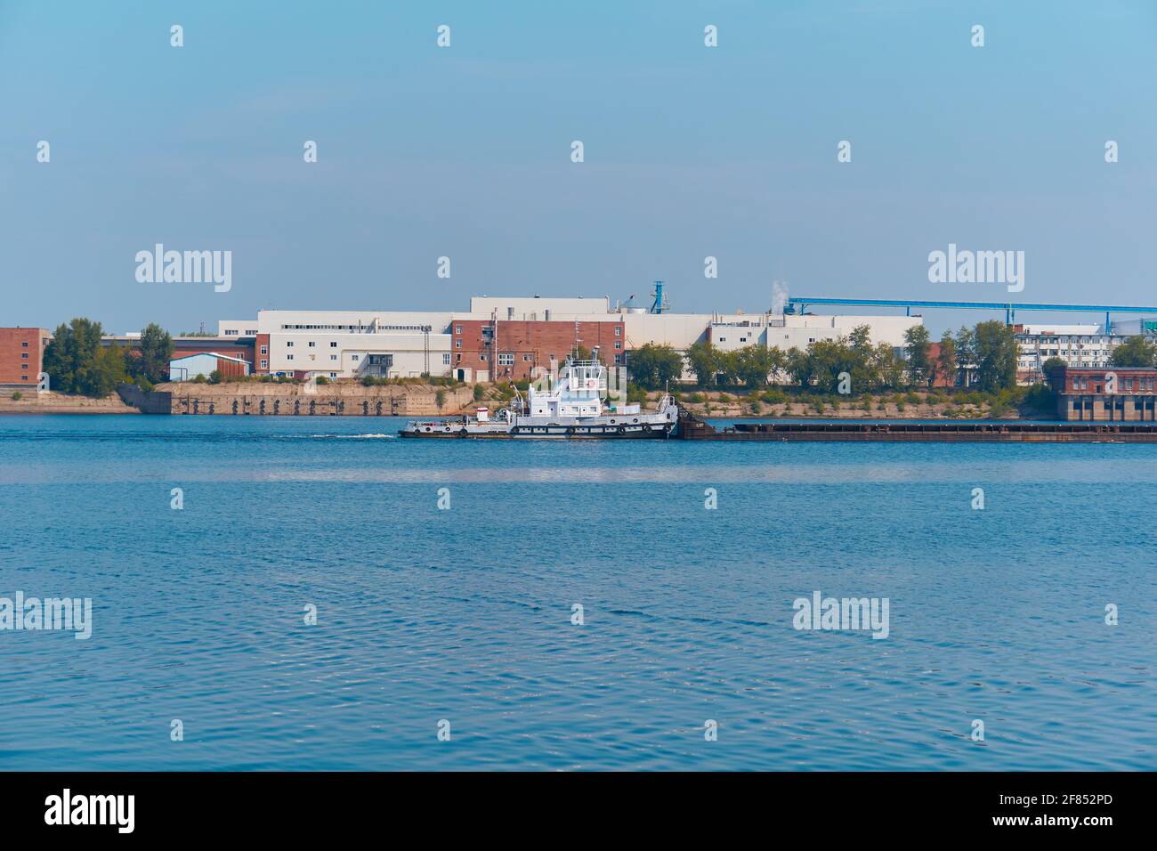 pusher boat pushes dry bulk cargo barge on the river past the ...