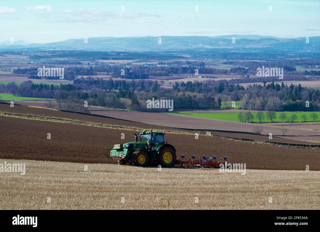 John Deere R series tractor with 5 furrow plough, ploughing stubble ...