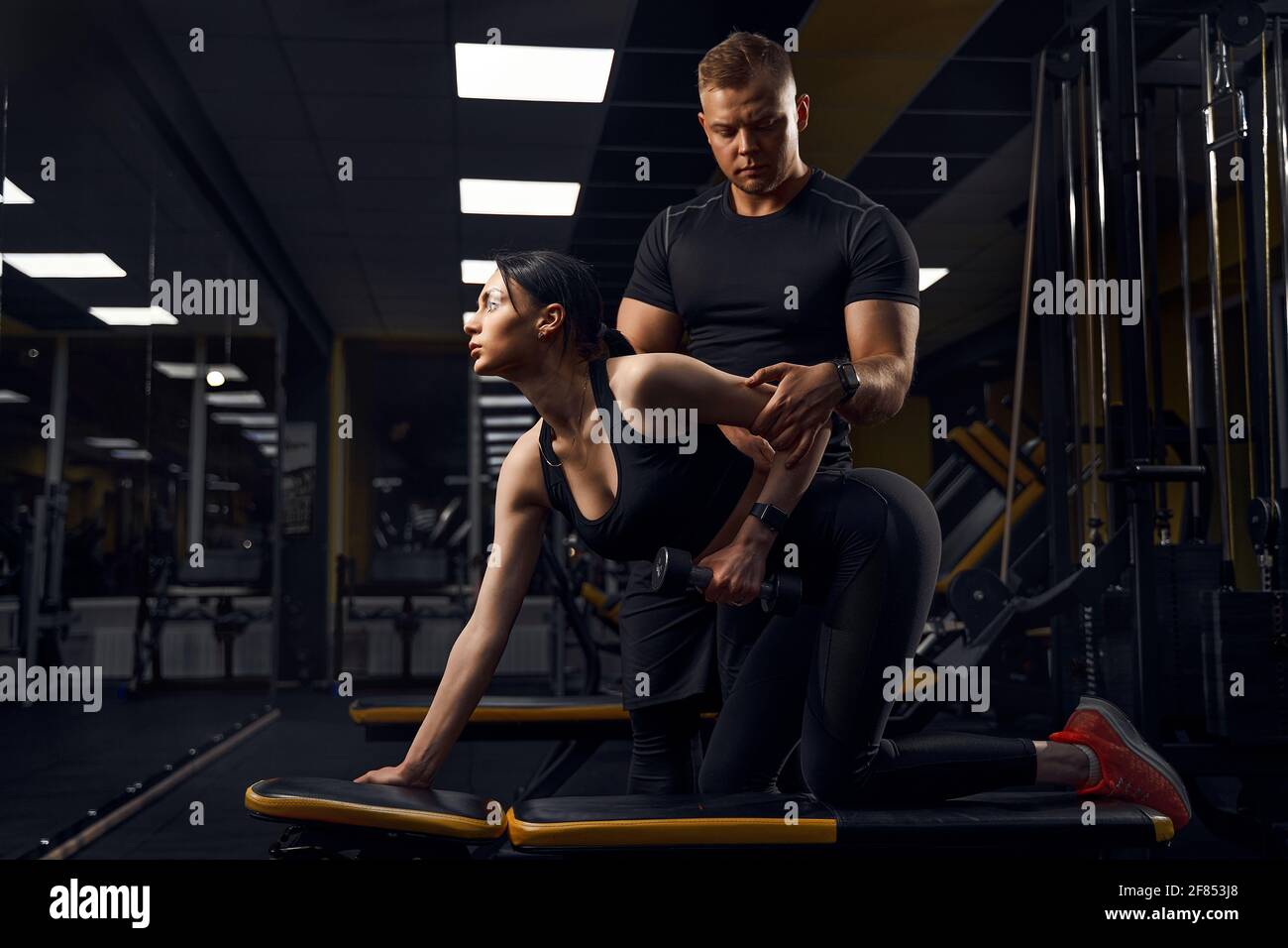 Personal Trainer Helping Woman Working Lift Heavy Dumbbells Two Hand