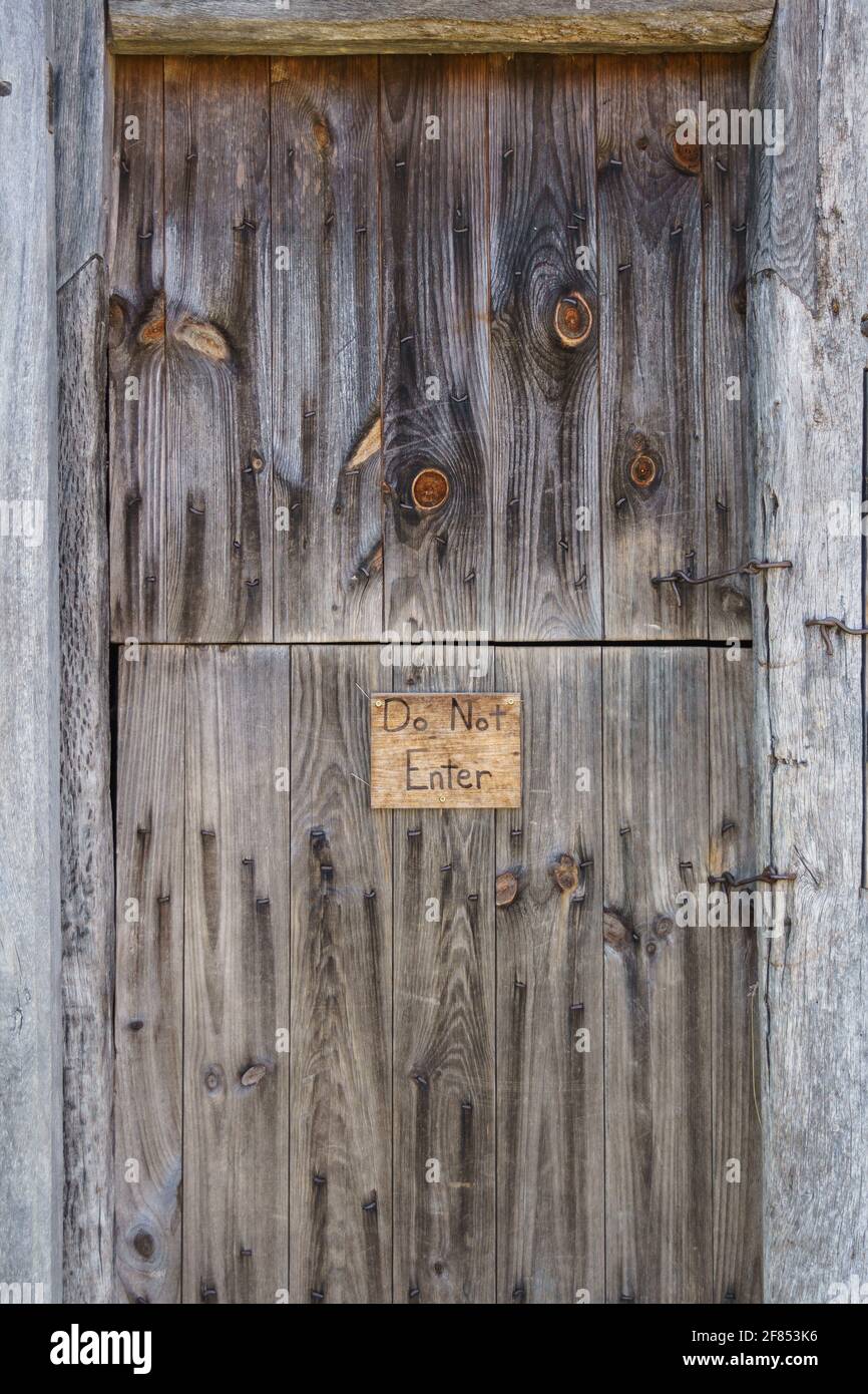 Do not enter sign on a rustic farm barn door. Wood is weathered and ...