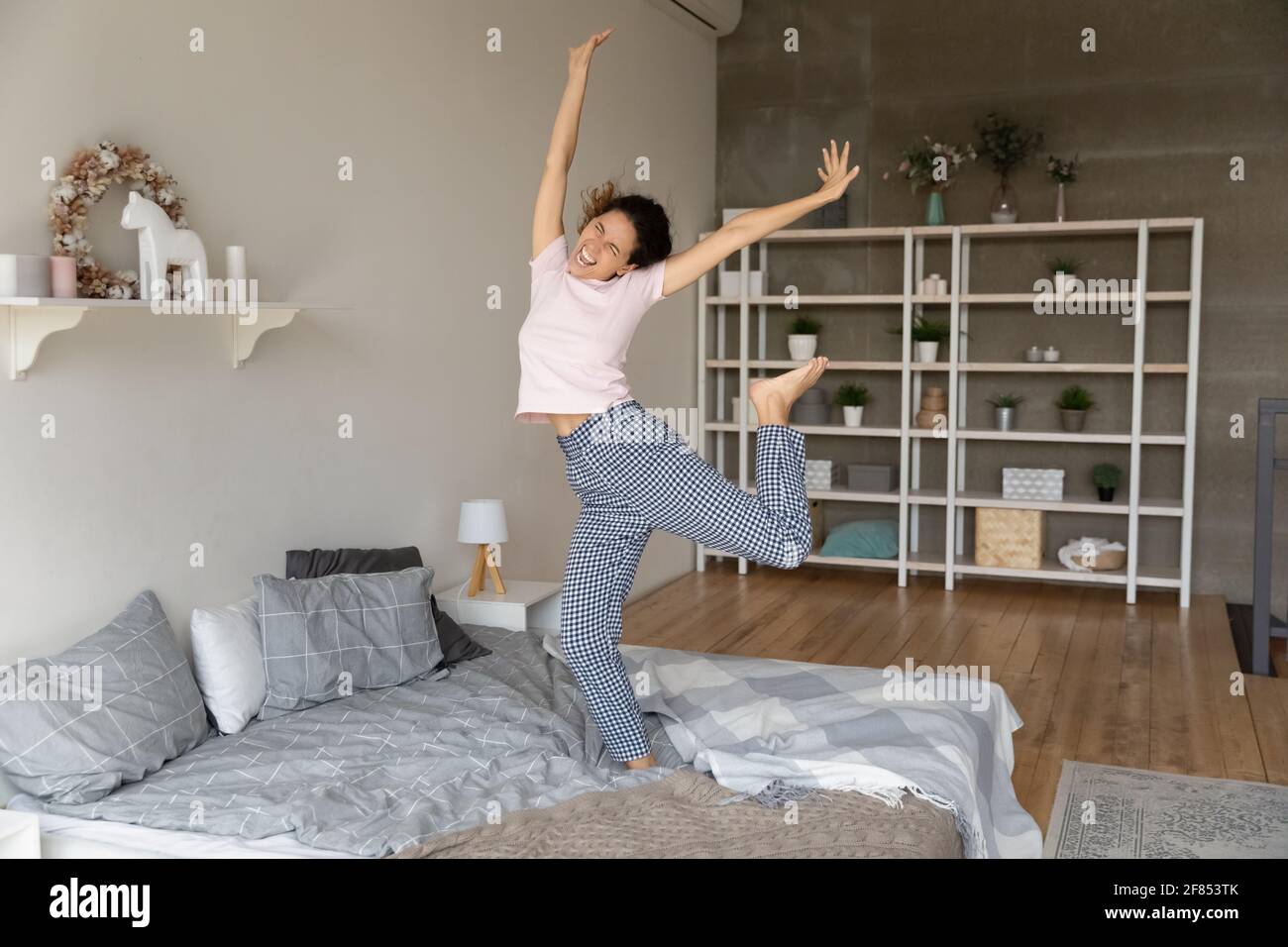 Funny teen female dance on bed enjoy good happy life Stock Photo - Alamy
