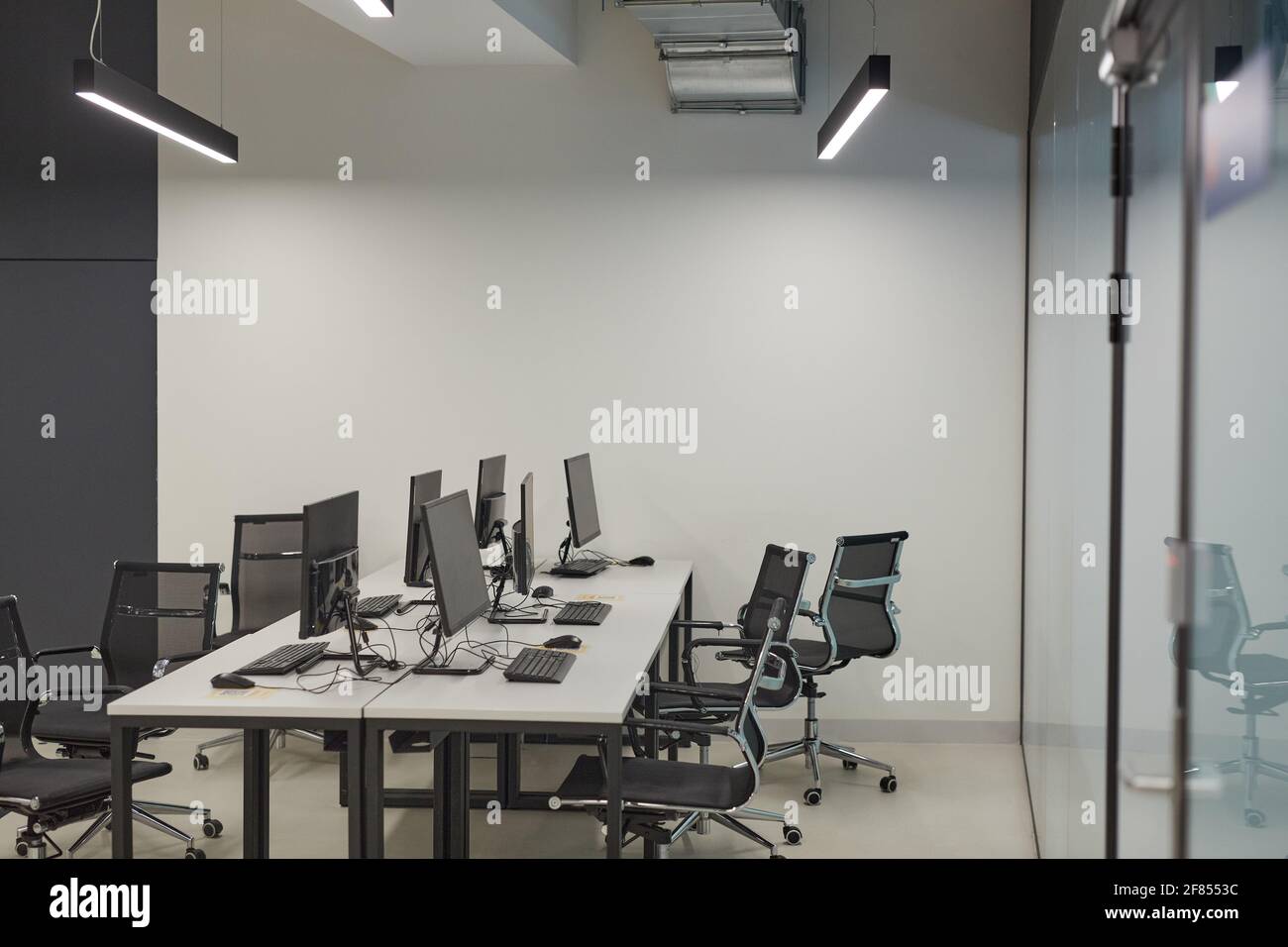 Background image of empty office with multiple computer desks and ...