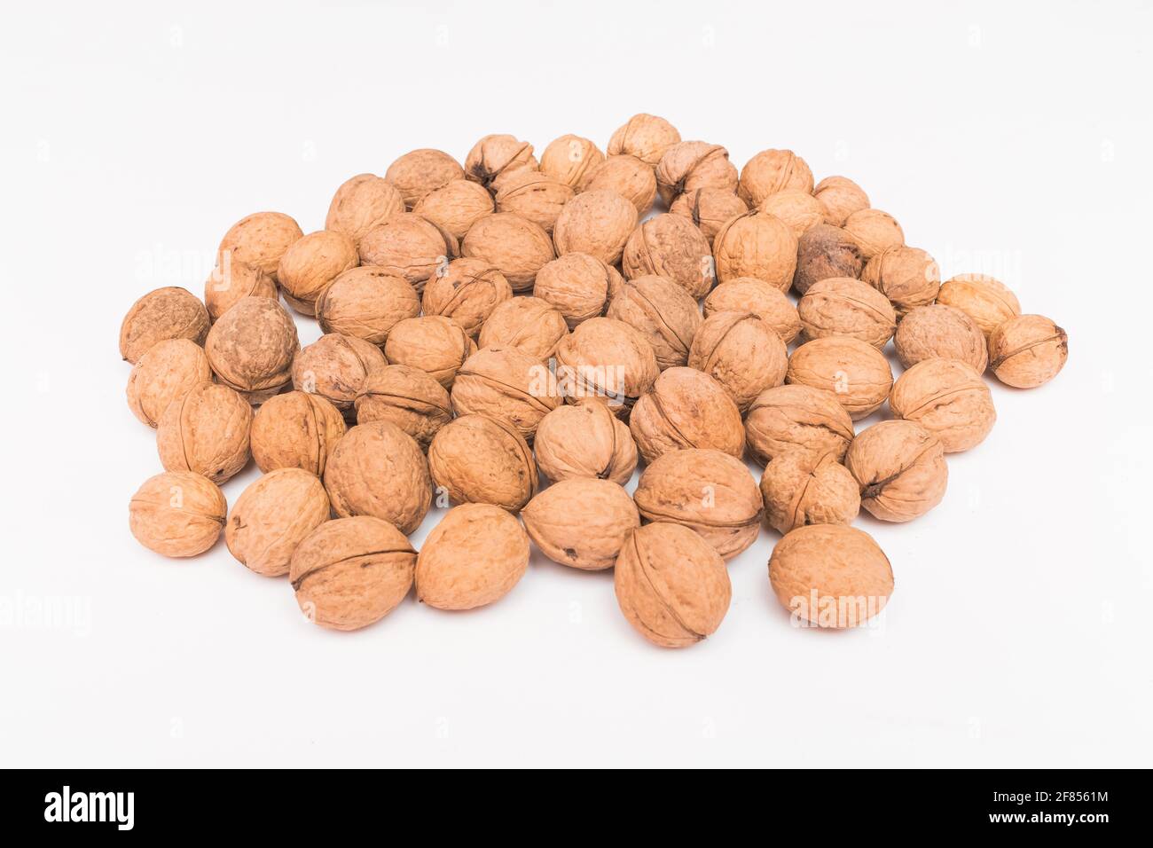 Heap of whole walnuts in the shell isolated on white background Stock ...