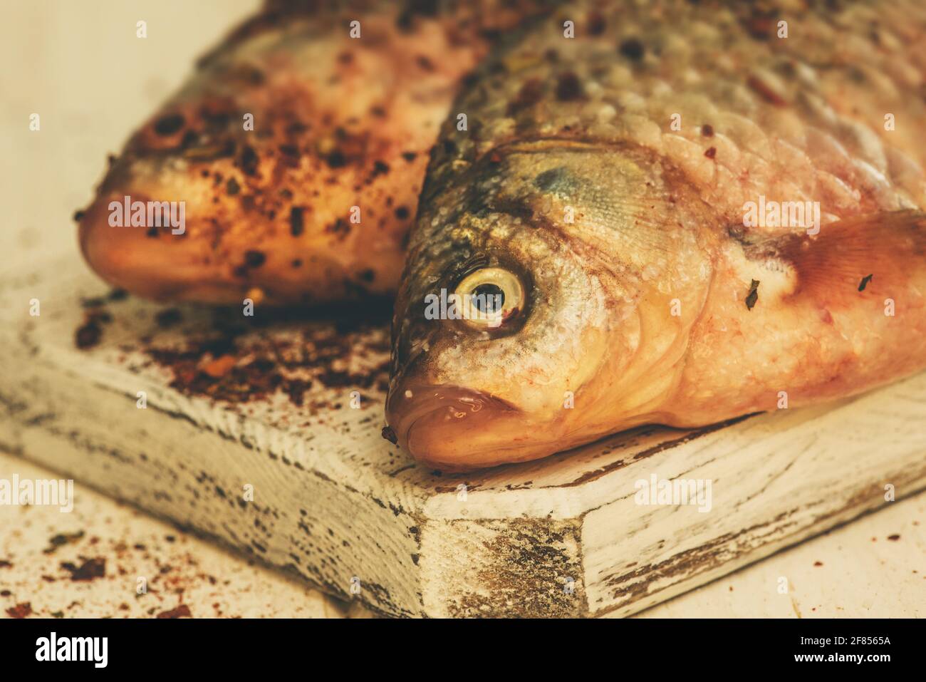 Fresh fish. Raw fish on white wood background. Fish on a white wooden ...