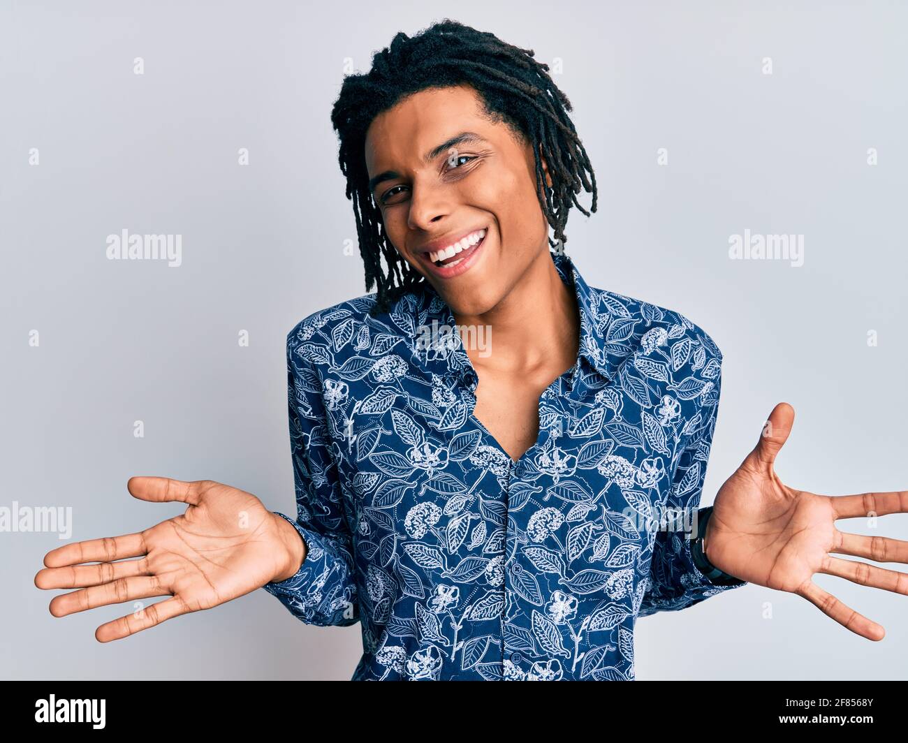 Young african american man wearing 80s style shirt clueless and ...