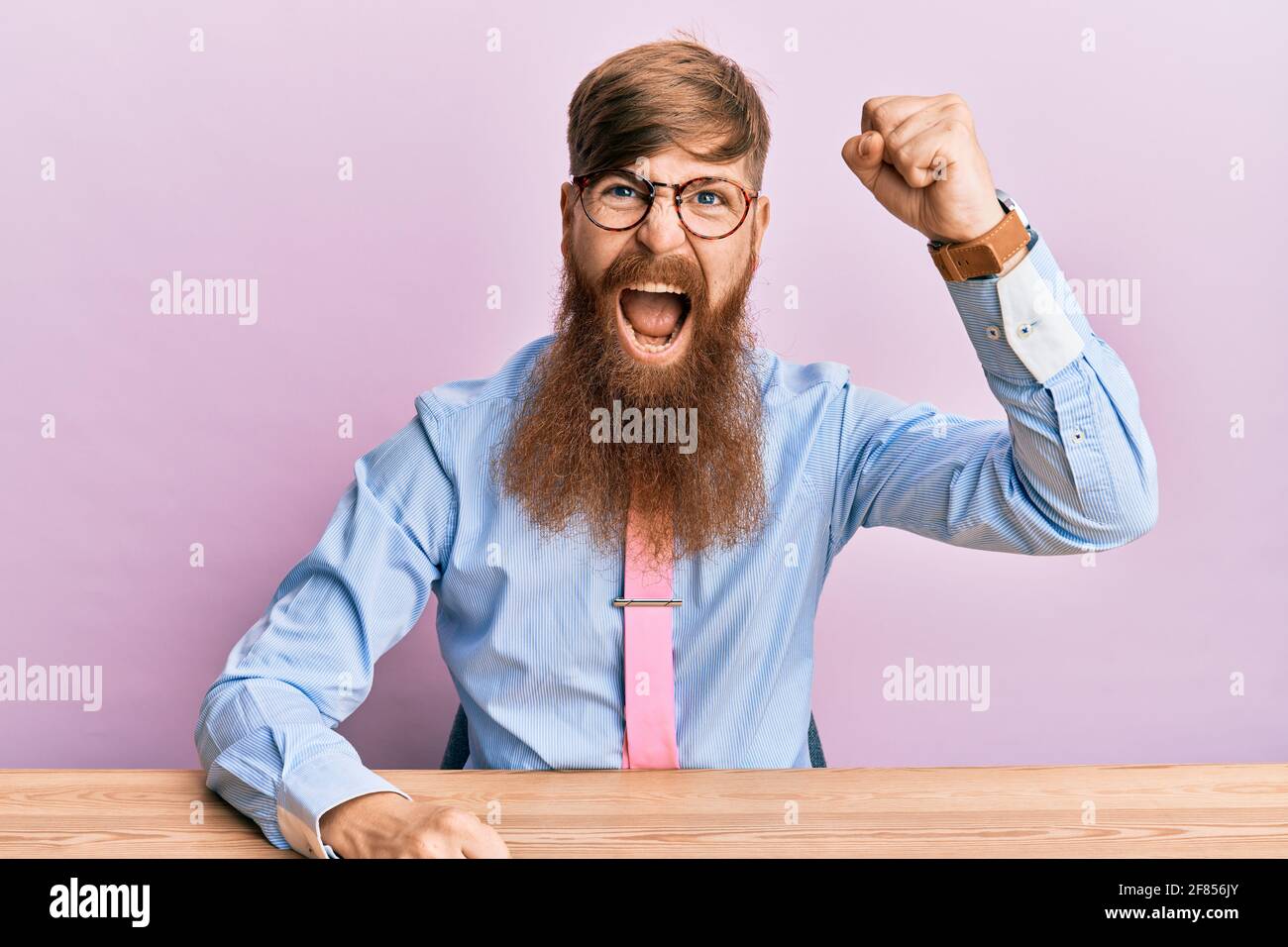 Young irish redhead man wearing business shirt and tie sitting on the ...