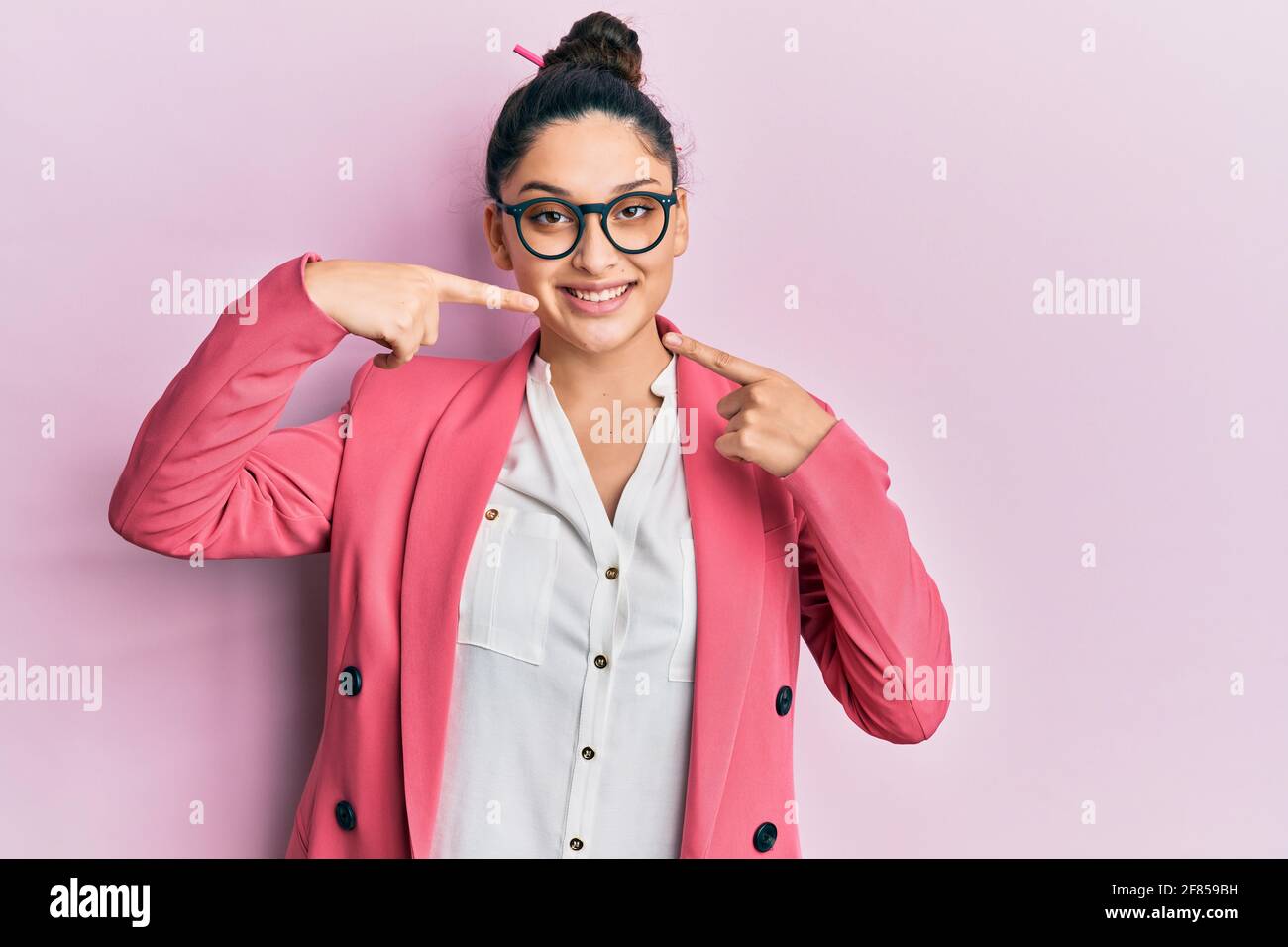 Beautiful middle eastern woman wearing business jacket and glasses ...