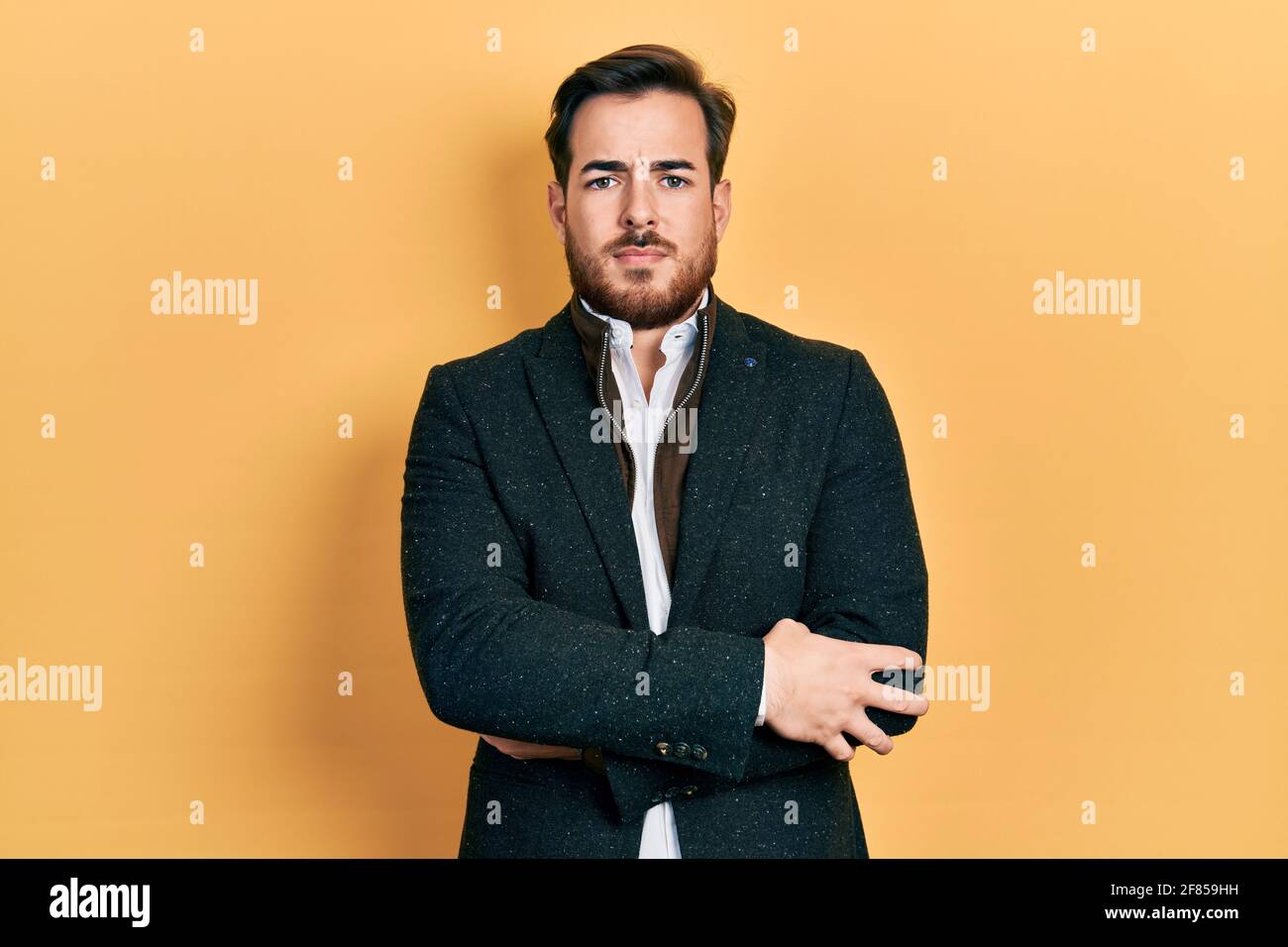 Handsome caucasian man with beard wearing elegant business jacket ...