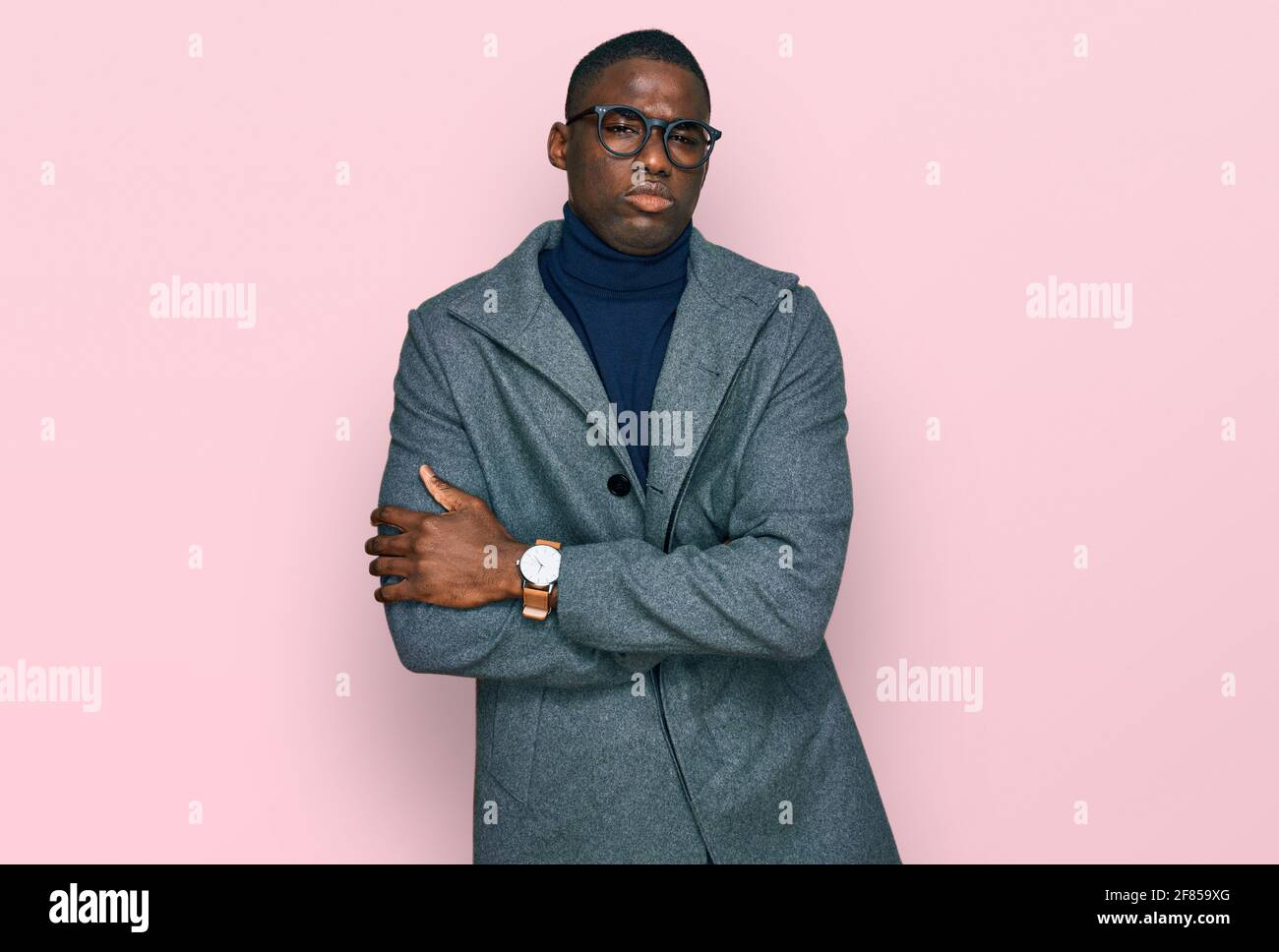 Young african american man wearing business clothes and glasses skeptic ...