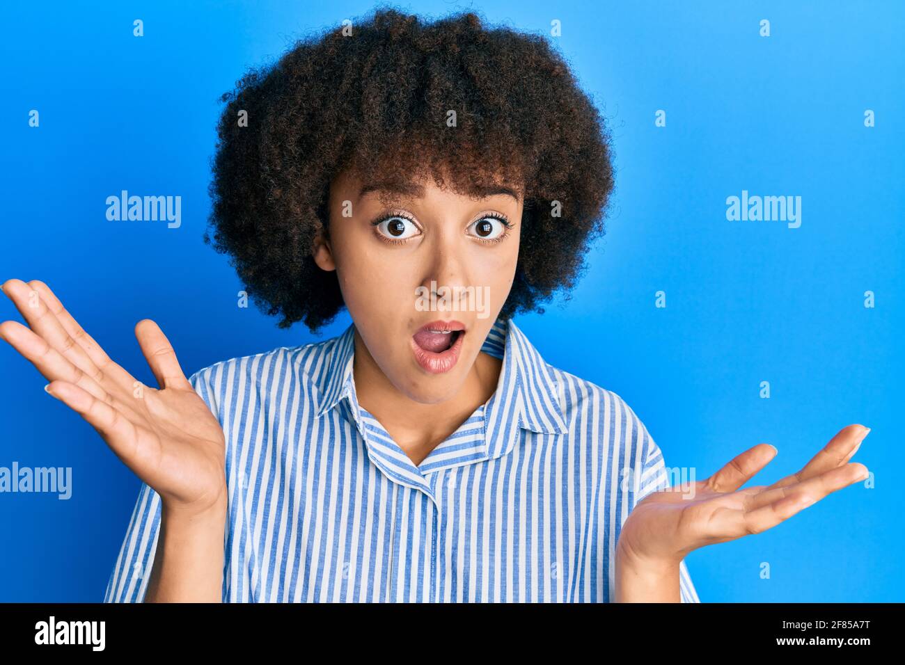 Young hispanic girl wearing casual clothes clueless and confused with ...