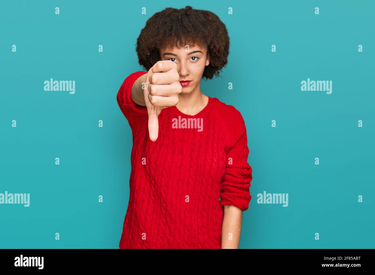 Young hispanic girl wearing casual clothes looking unhappy and angry ...