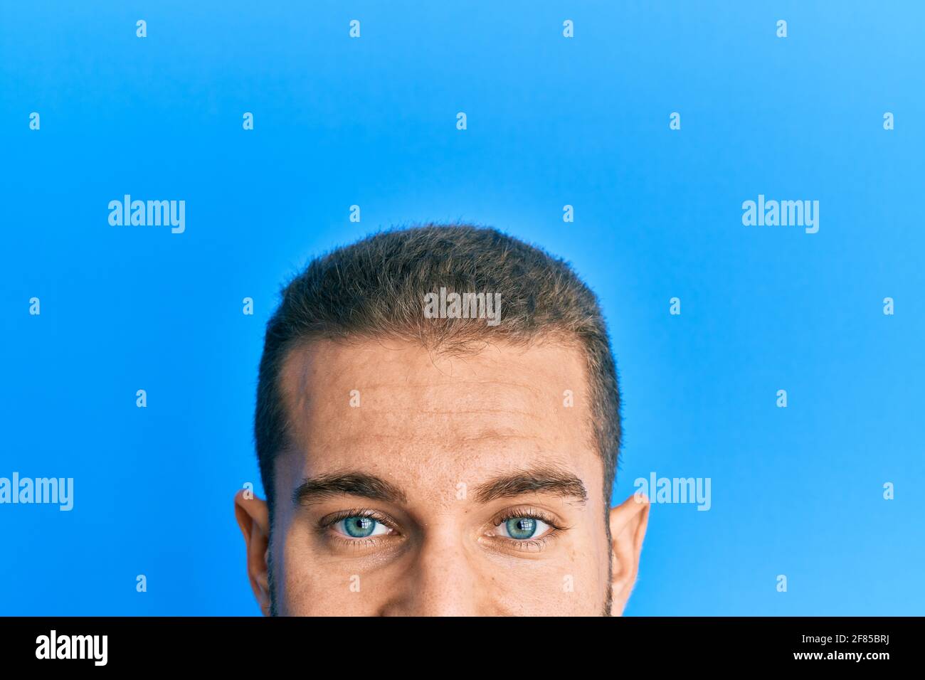 Young caucasian man showing head and half face smiling with a happy and ...