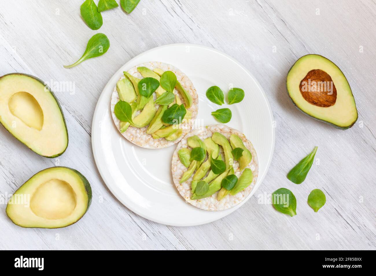 Crispy rice cakes with sliced avocado. Healthy and fresh breakfast ...