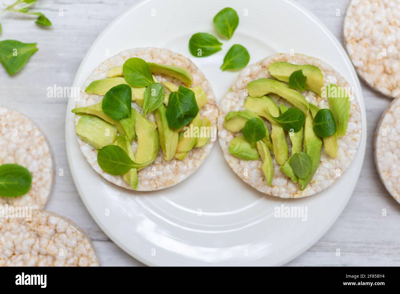 Crispy rice cakes with sliced avocado. Healthy and fresh breakfast ...