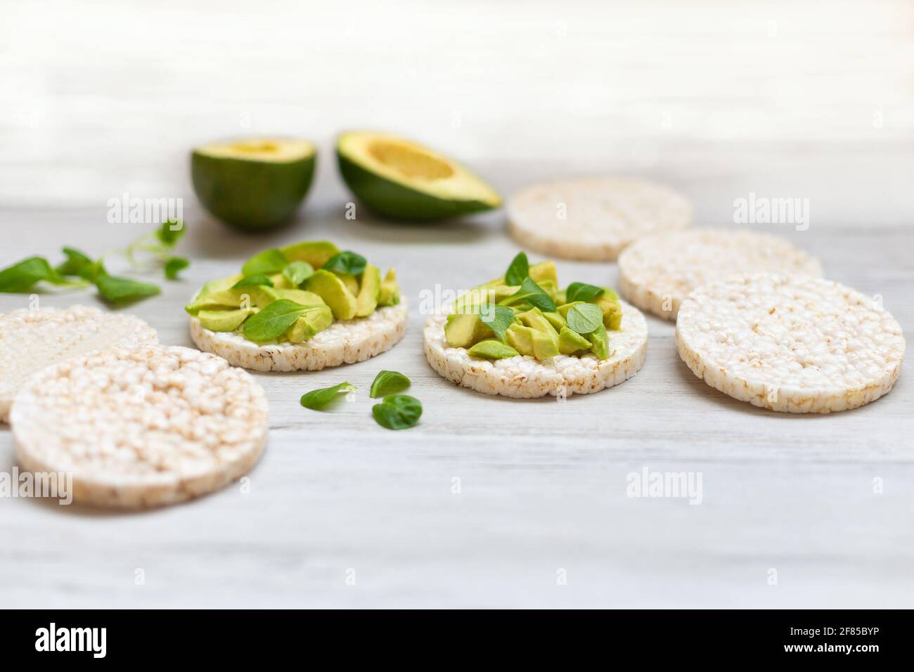 Crispy rice cakes with sliced avocado. Healthy and fresh breakfast ...
