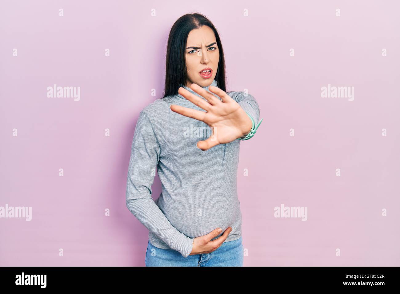Beautiful woman with blue eyes expecting a baby, touching pregnant ...