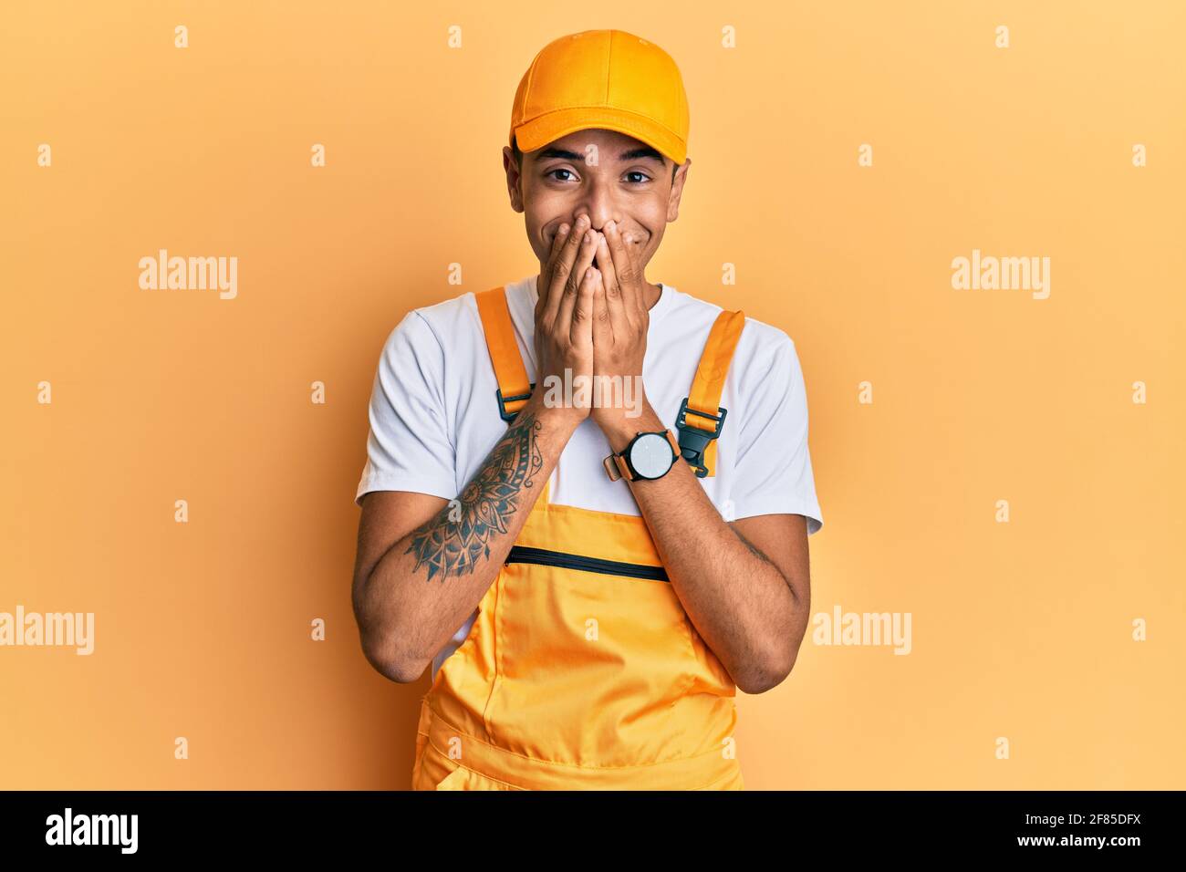 Young handsome african american man wearing handyman uniform over ...