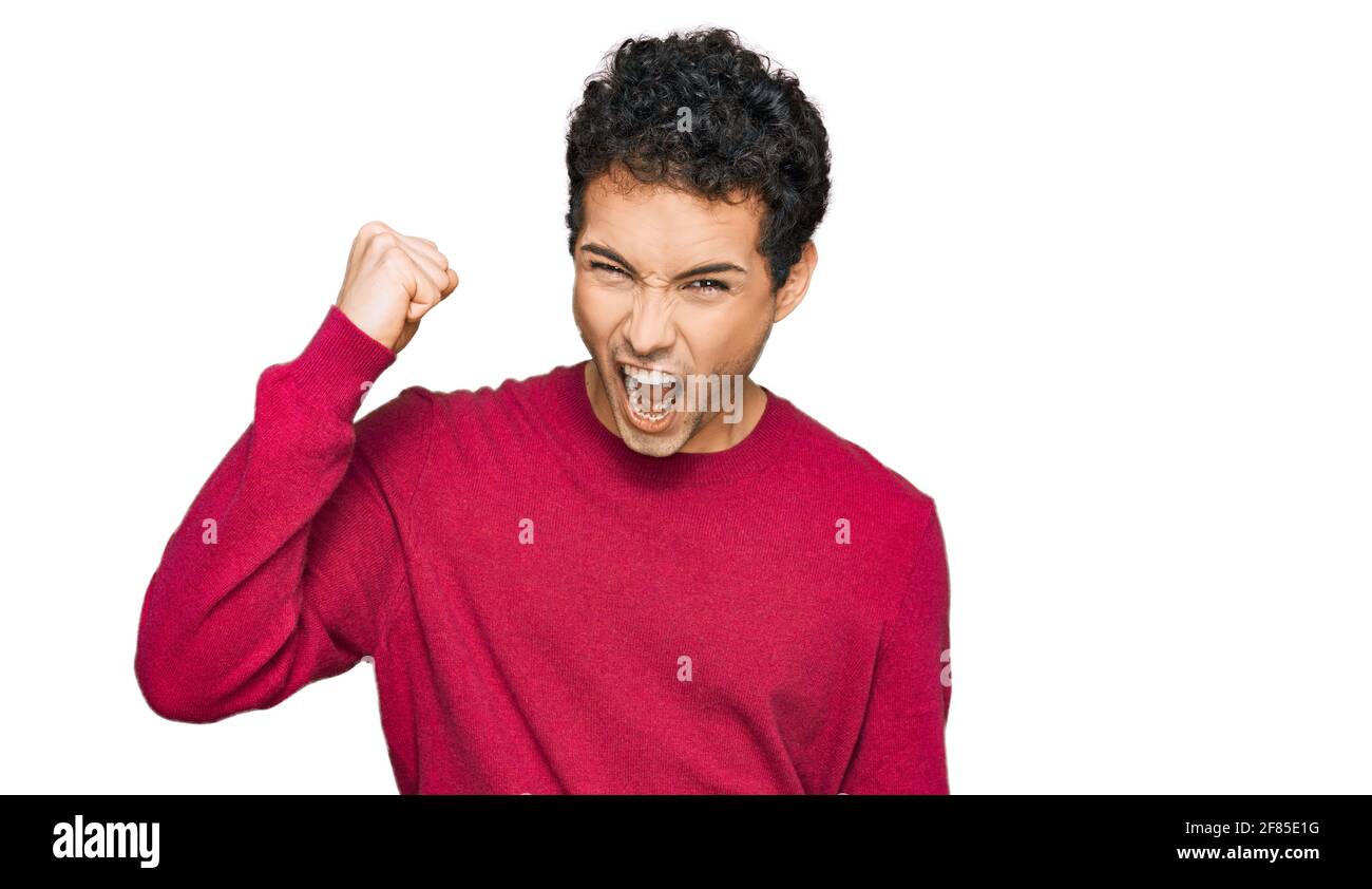 Young handsome man wearing casual clothes angry and mad raising fist ...