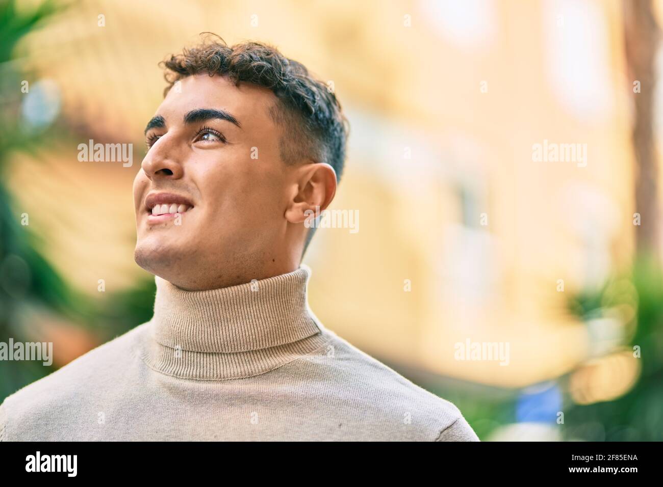 Young hispanic man smiling happy standing at the city Stock Photo - Alamy