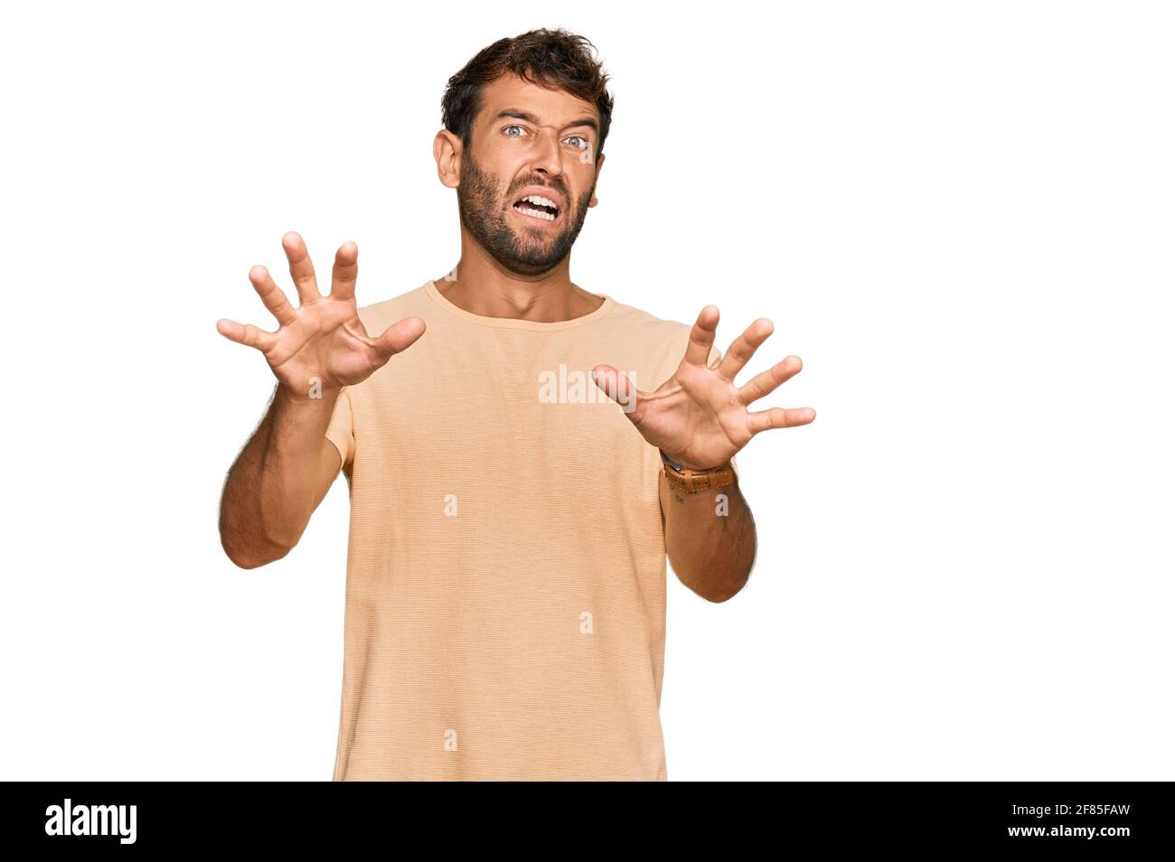 Handsome young man with beard wearing casual tshirt afraid and ...