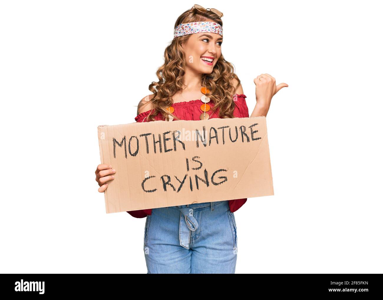 Young blonde girl wearing hippie style holding mother nature is crying ...