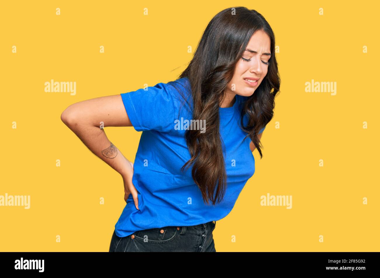 Beautiful brunette young woman wearing casual clothes suffering of ...