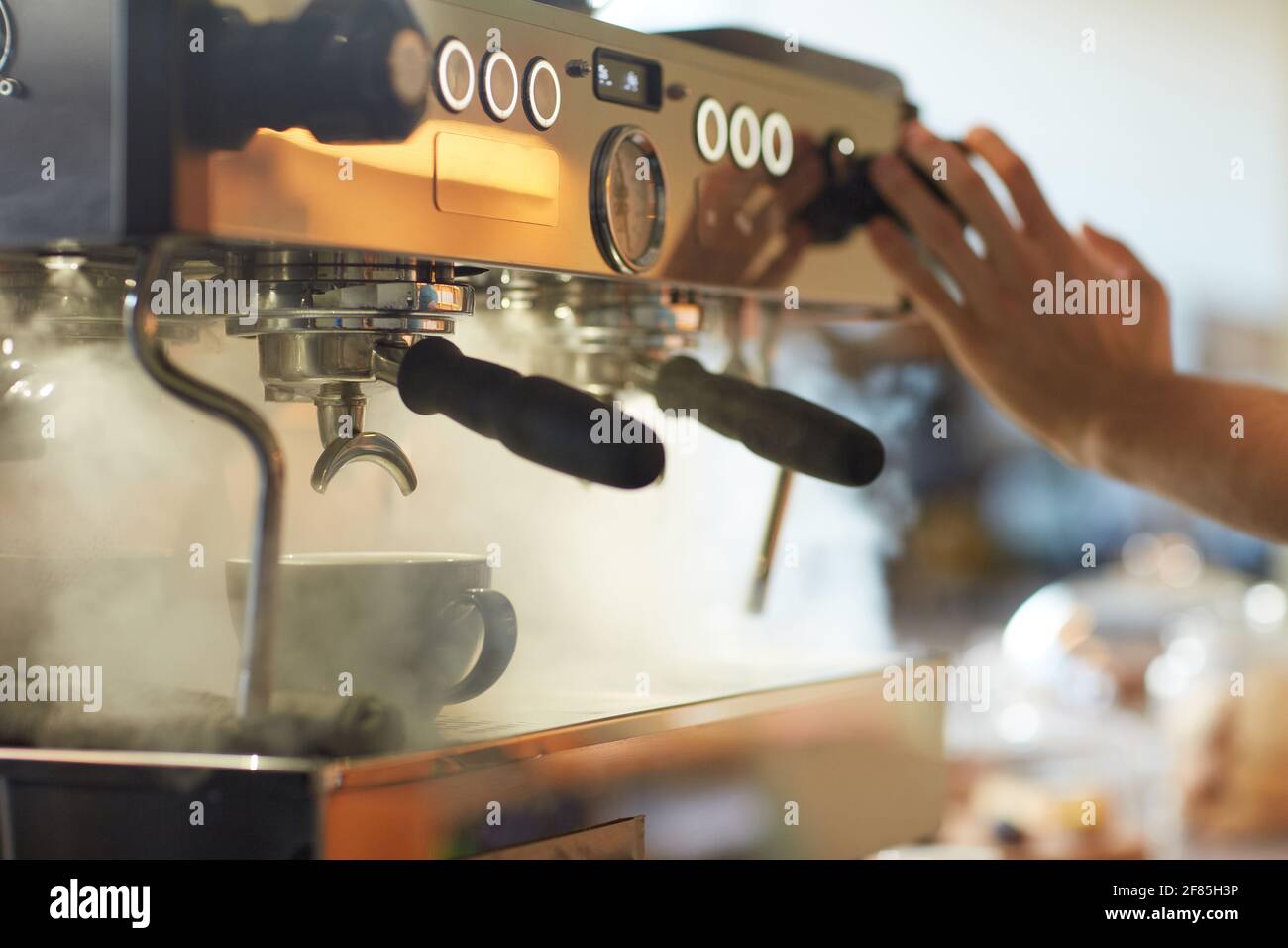 Close up of steaming coffee machine in cafe or coffee shop with ...