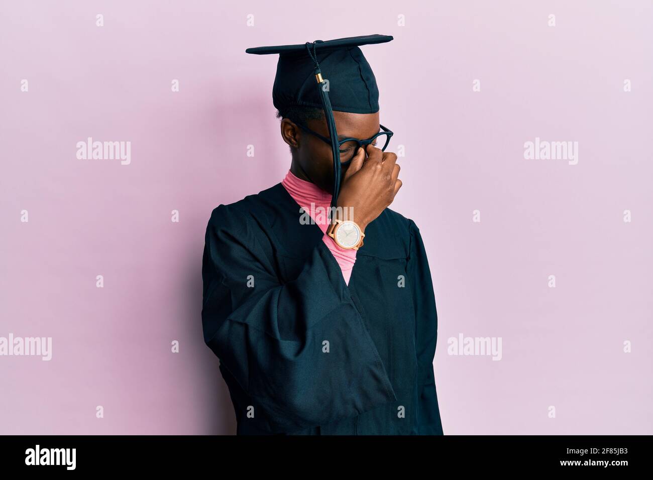 Young african american girl wearing graduation cap and ceremony robe ...