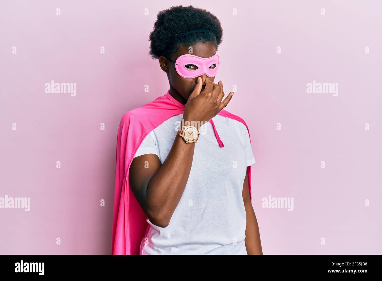 Young african american girl wearing superhero mask and cape costume ...
