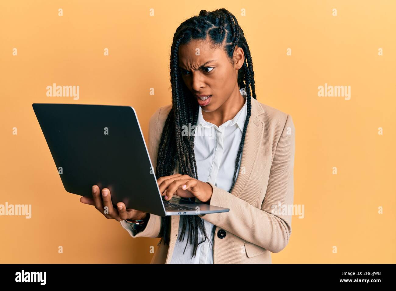African american woman working using computer laptop angry and mad ...