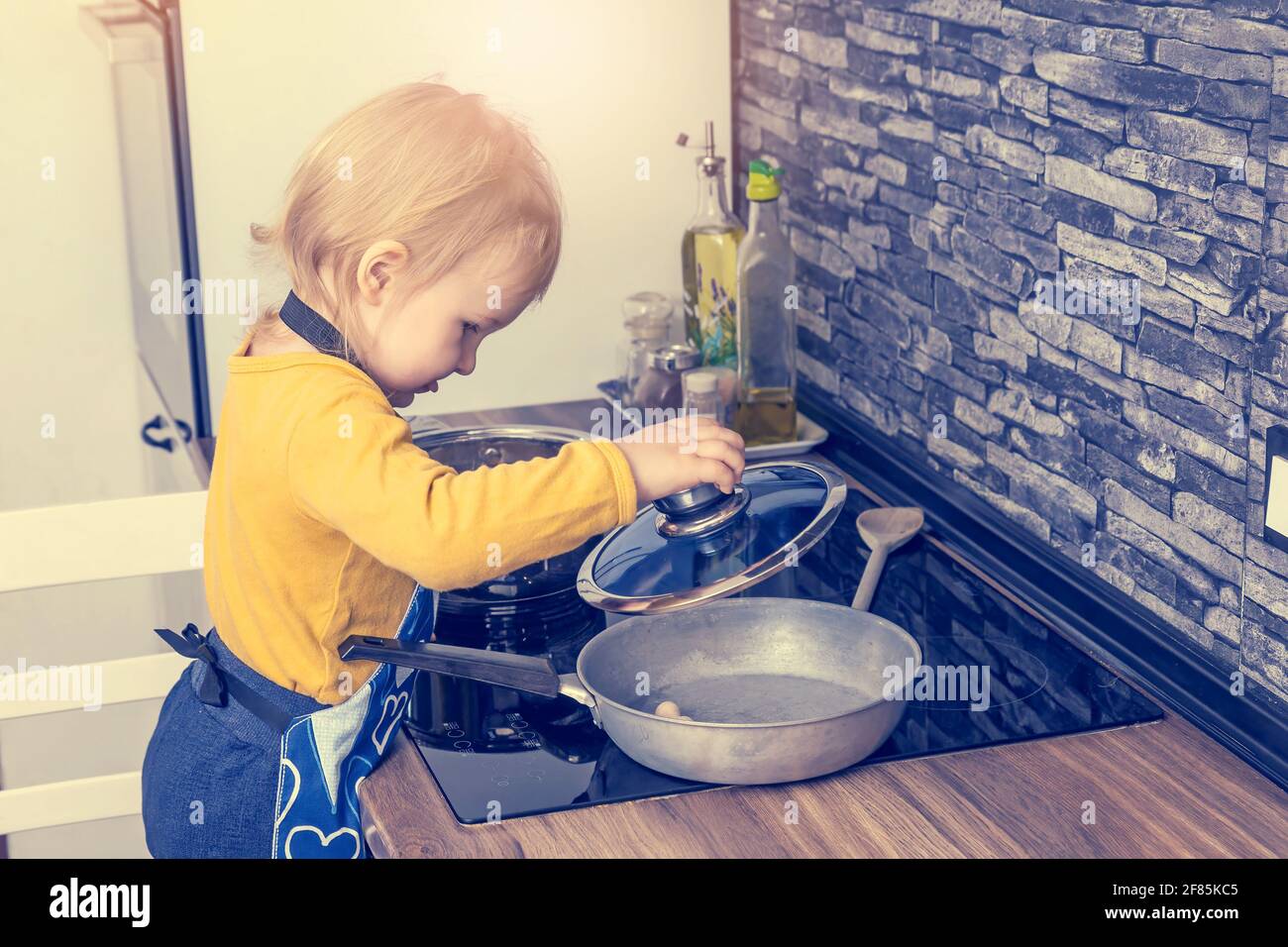 Cute little boy is cooking in the kitchen. Horizontally Stock Photo - Alamy