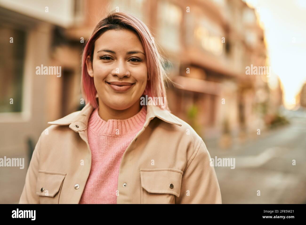 Young hispanic girl smiling happy standing at the city Stock Photo - Alamy