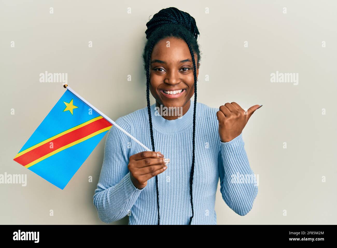 African american woman with braided hair holding democratic republic of ...