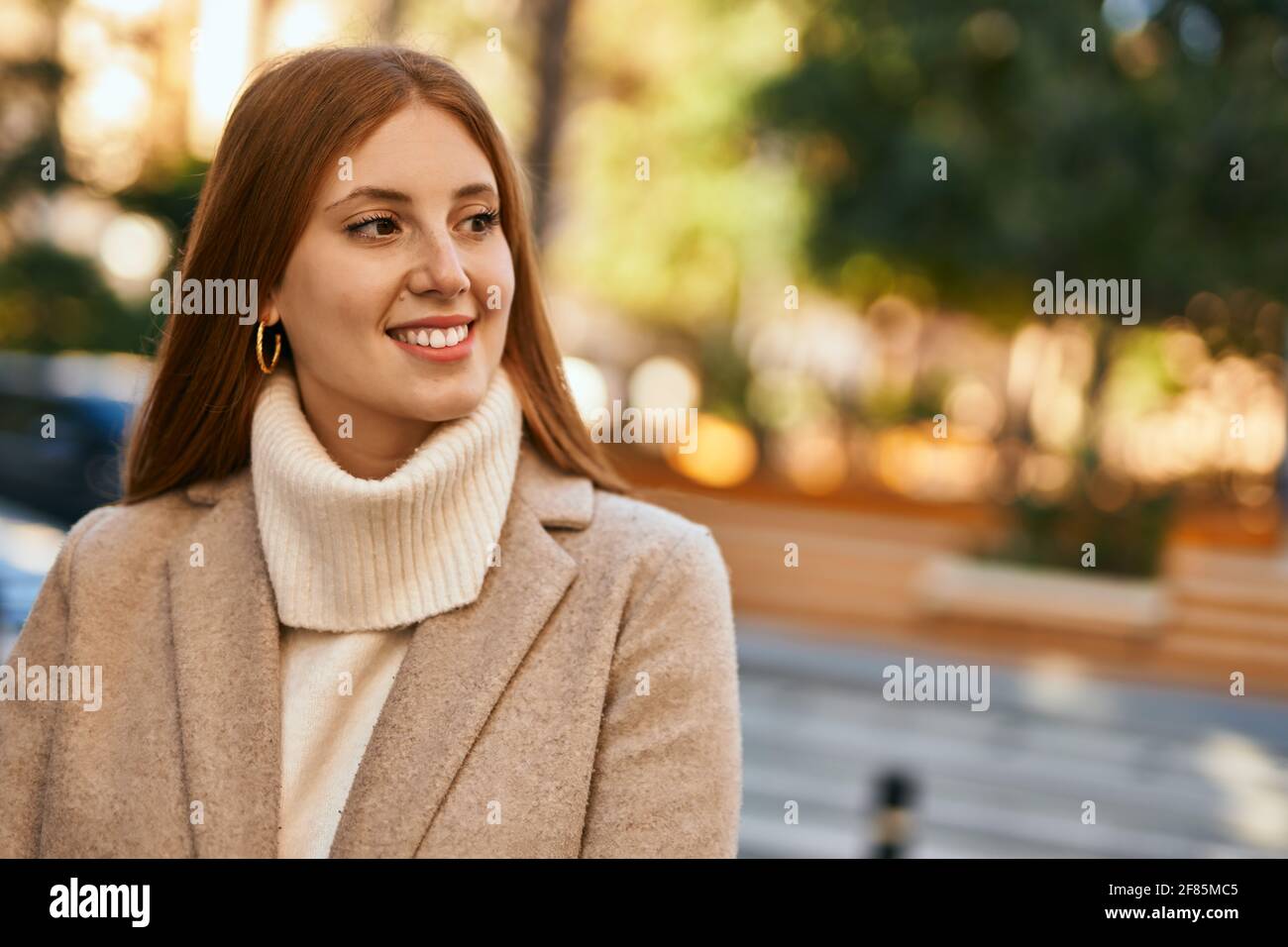 Young redhead girl smiling happy standing at the city Stock Photo - Alamy