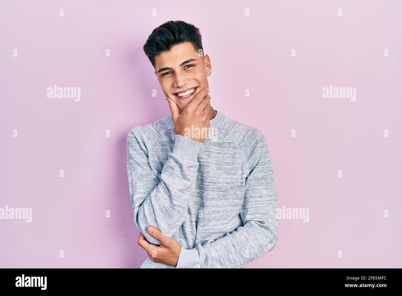 Young hispanic man wearing casual clothes looking confident at the ...