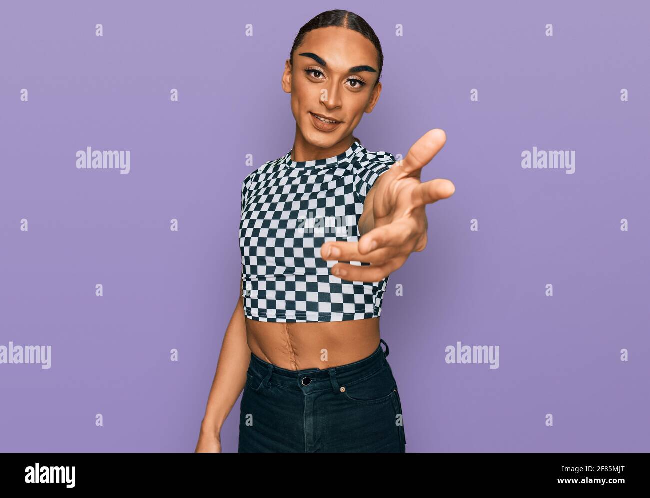 Hispanic transgender man wearing make up and long hair wearing modern ...