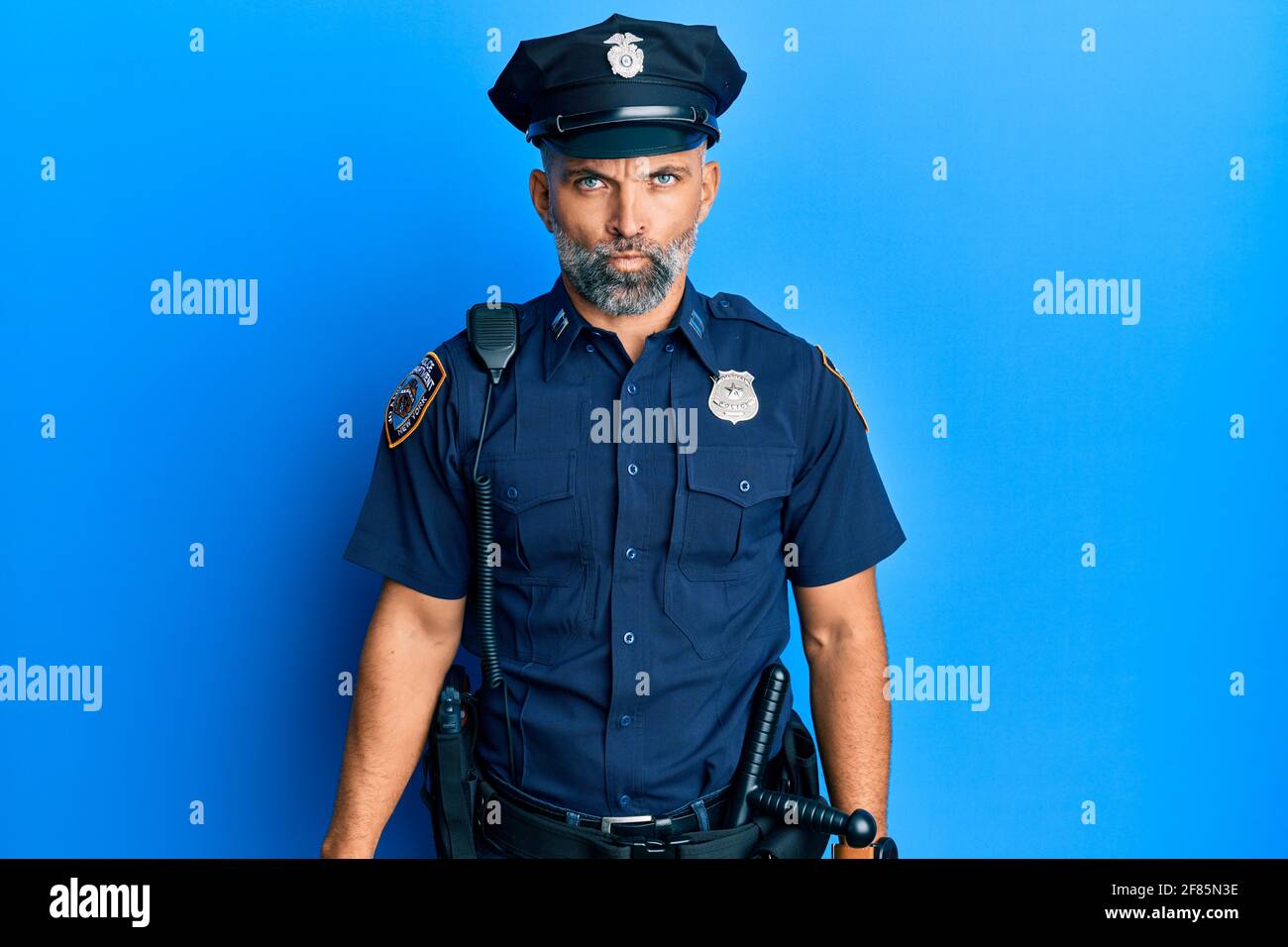 Middle age handsome man wearing police uniform skeptic and nervous ...