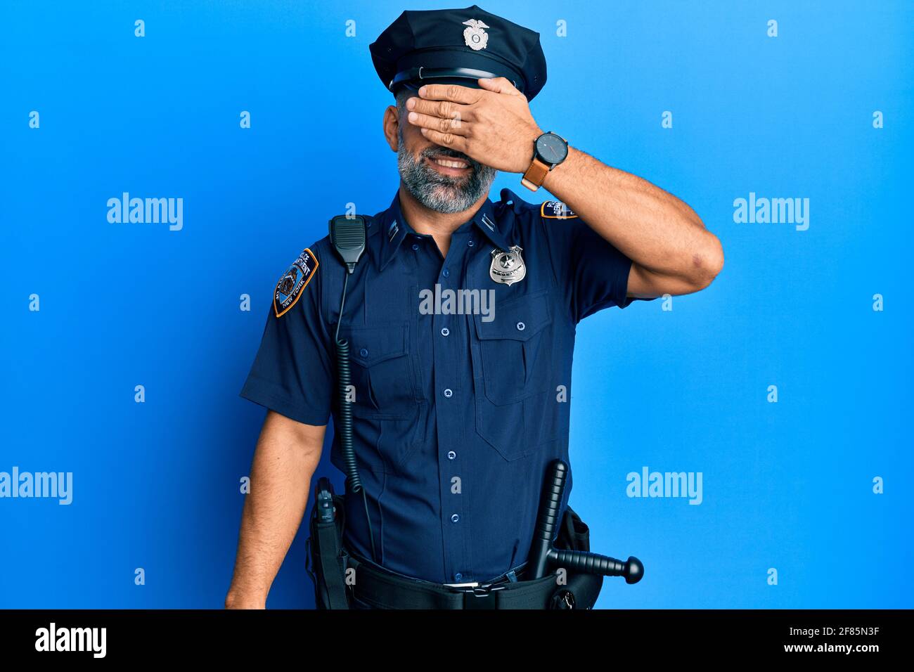 Middle age handsome man wearing police uniform smiling and laughing ...