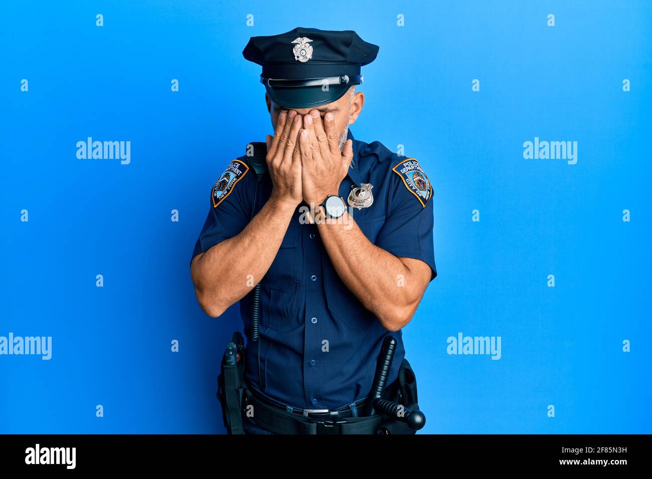 Middle age handsome man wearing police uniform rubbing eyes for fatigue ...