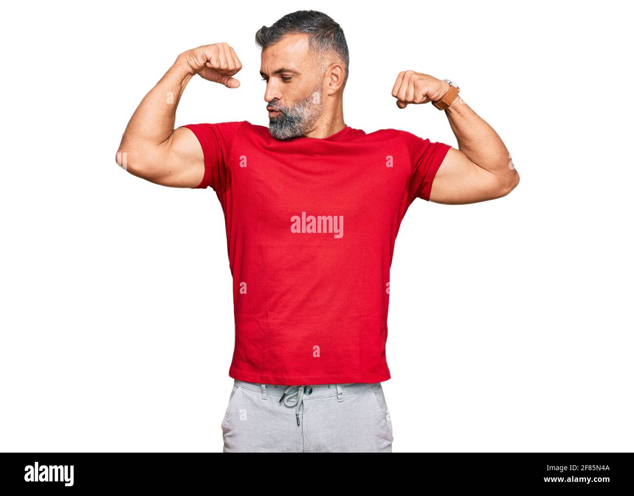 Middle age handsome man wearing casual clothes showing arms muscles ...