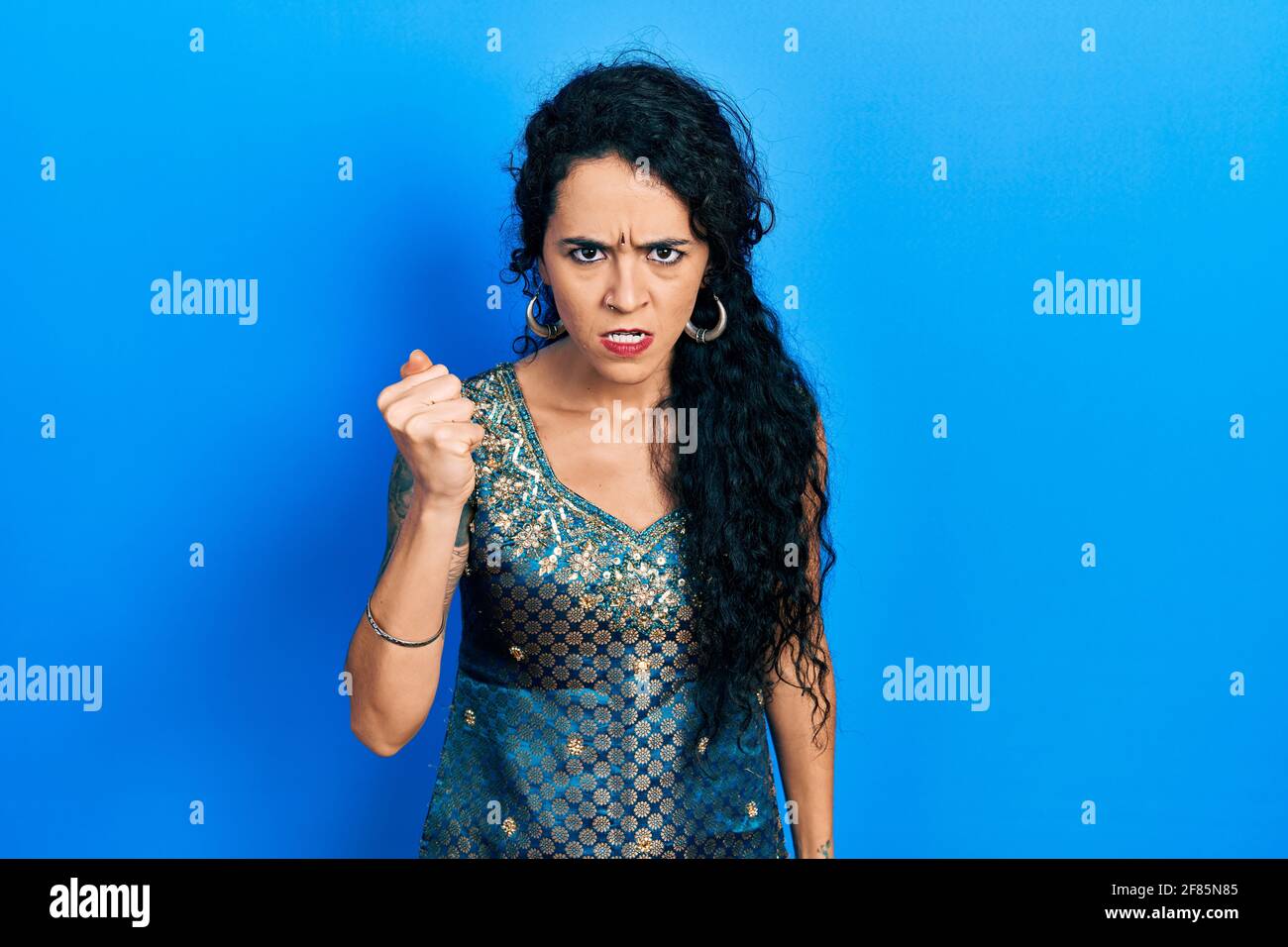 Young woman wearing bindi and traditional kurta dress angry and mad ...